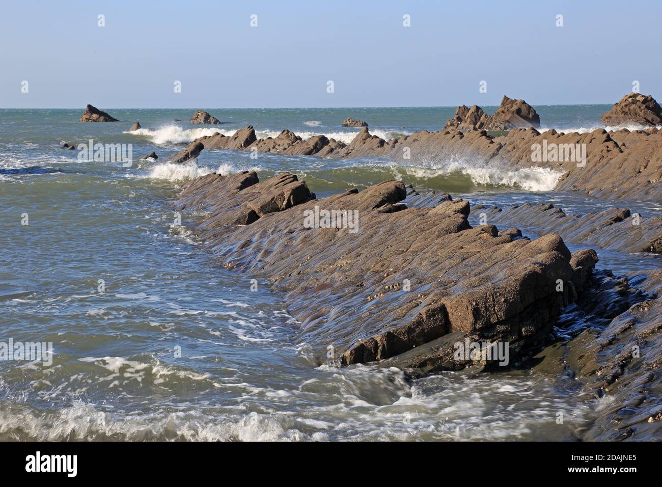View of the rock ledges at Welcombe Mouth Beach on the Devon and ...