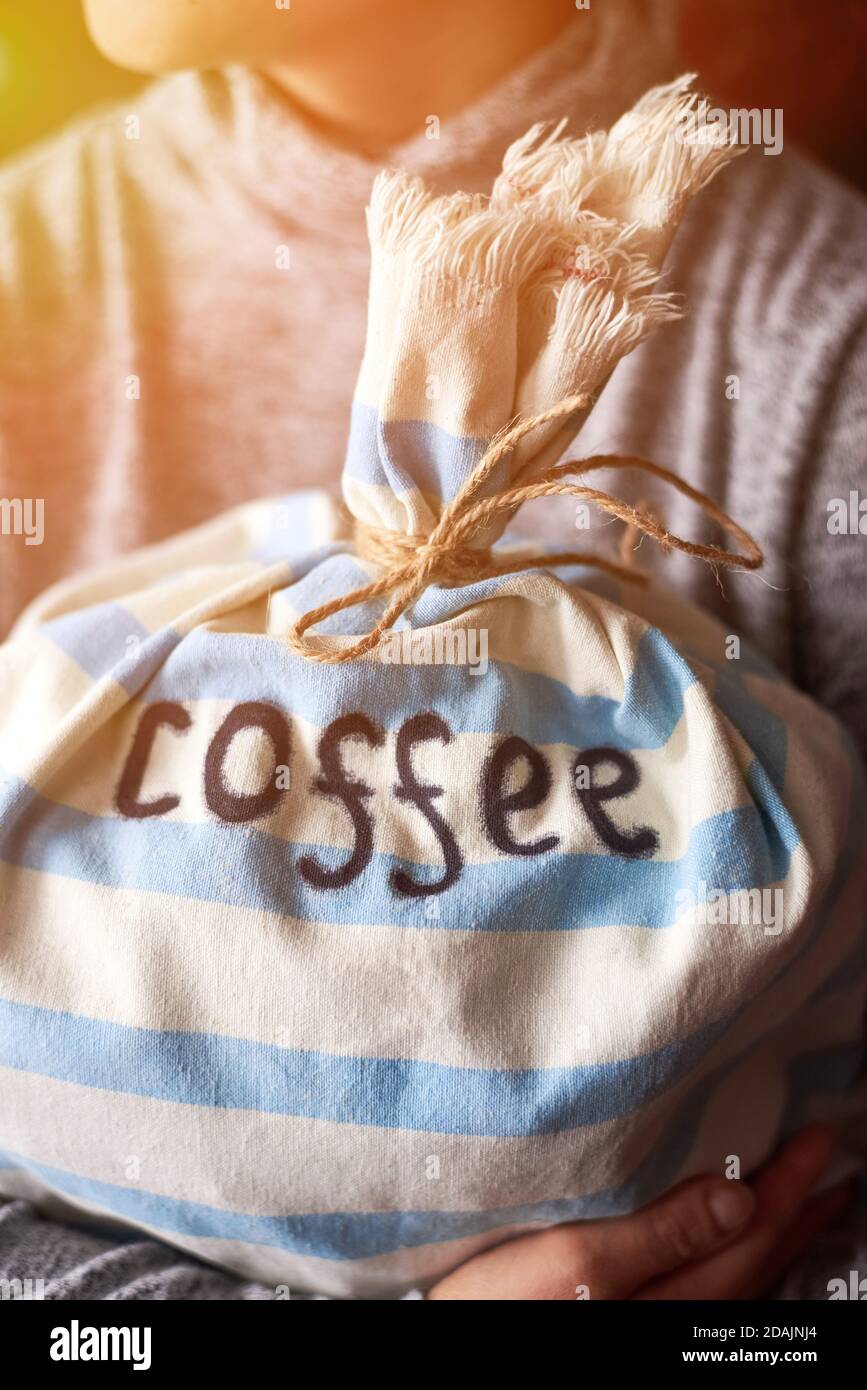 Woman hugs a big bag of coffee, toned photo Stock Photo - Alamy