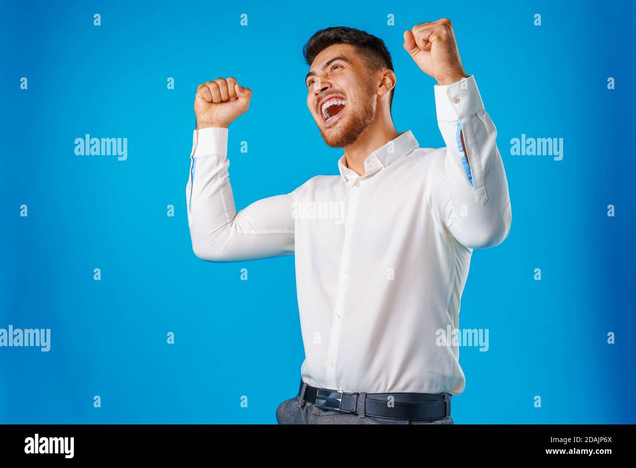 Portrait of excited, successful man raising hands up Stock Photo - Alamy