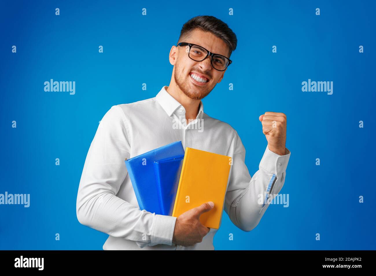 Overjoyed funny bearded man in glasses celebrating success Stock Photo ...
