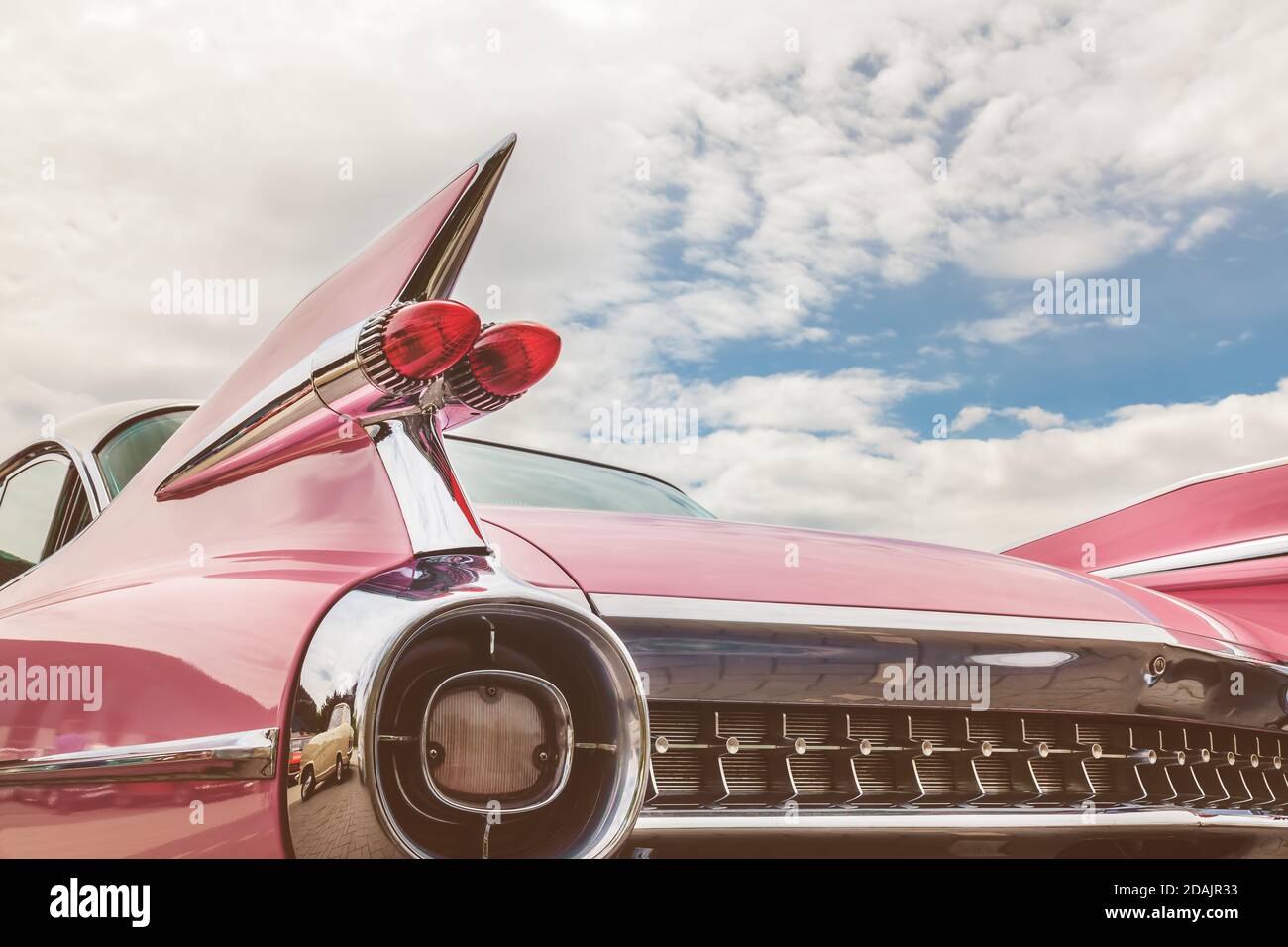 Retro styled image of the rear end of a pink classic car Stock Photo ...