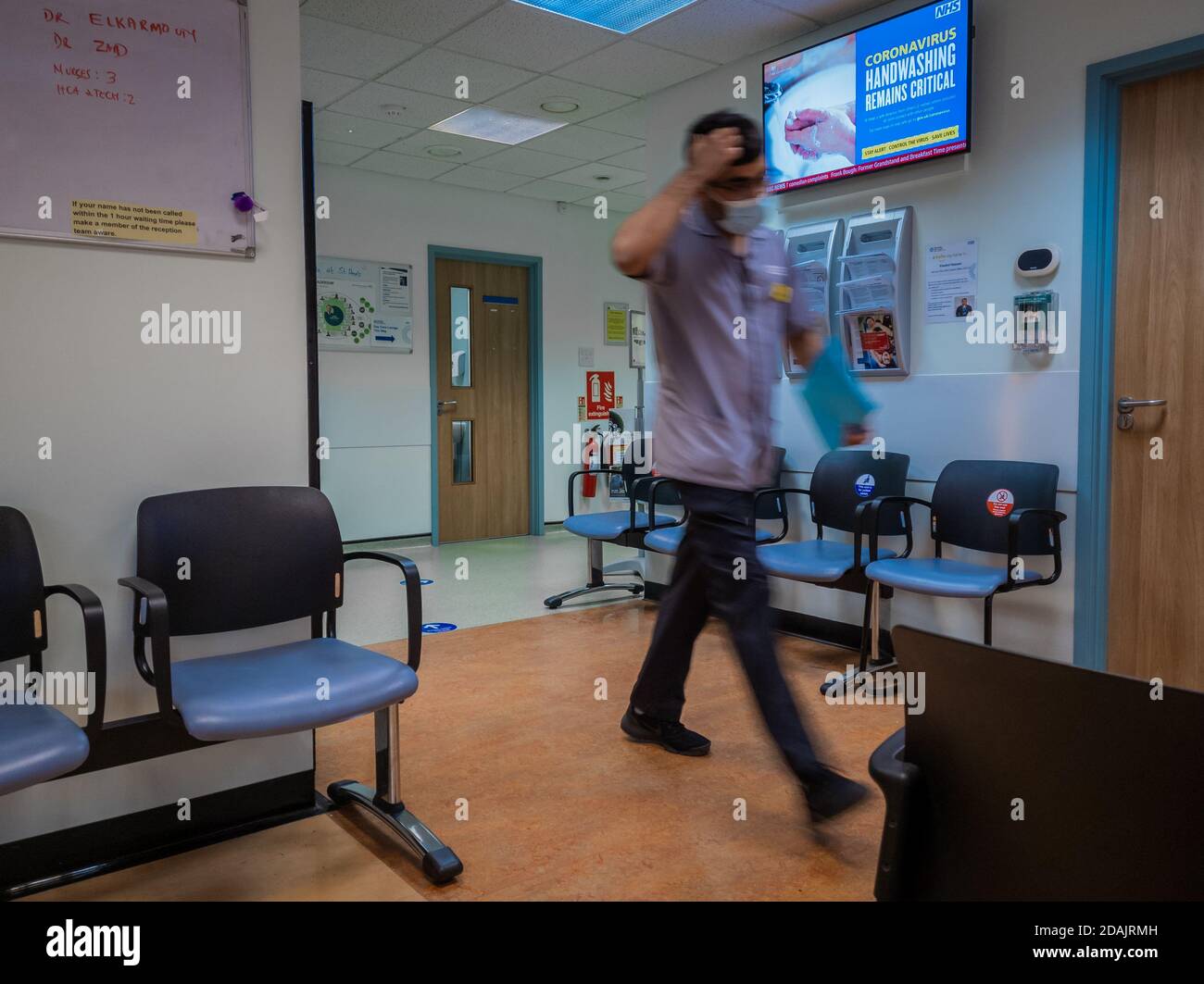 A NHS hospital reception and waiting room with Covid-19 safety measures ...