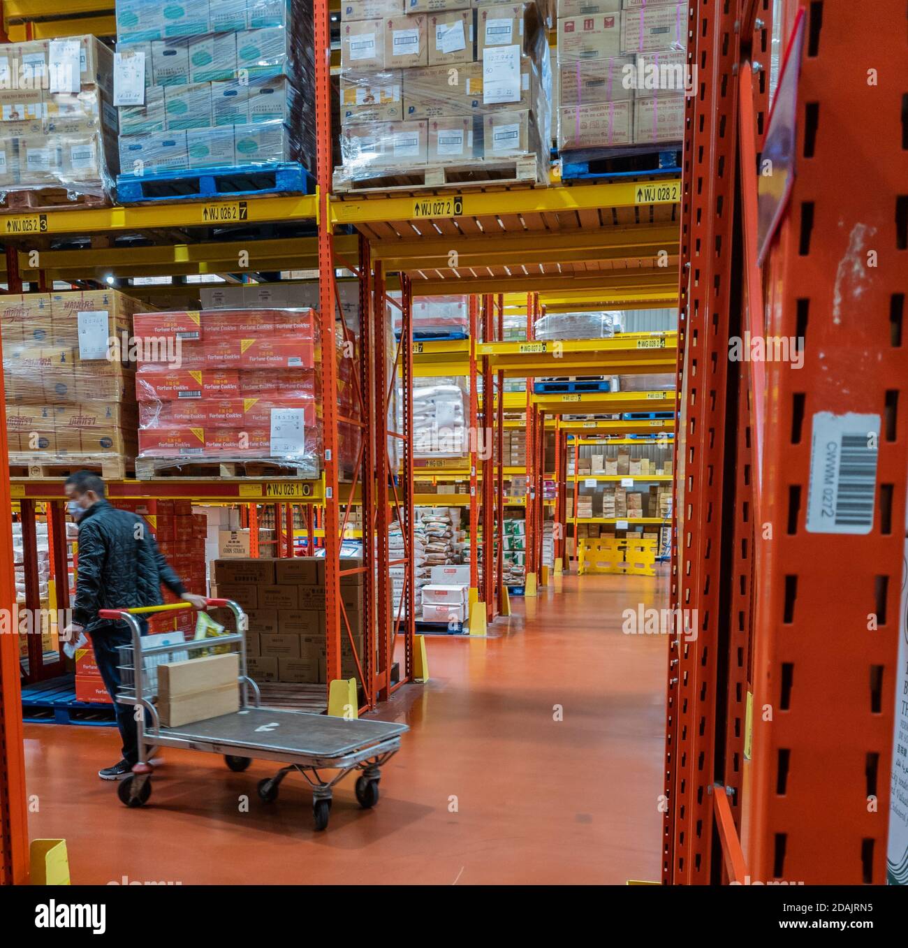 A supermarket warehouse packed with pallets and bulk packages of food ...
