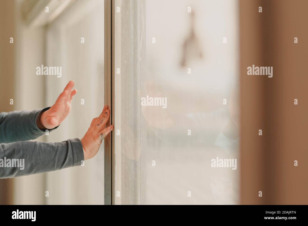 Man's hand reaching the glass sliding windows of a house Stock Photo ...
