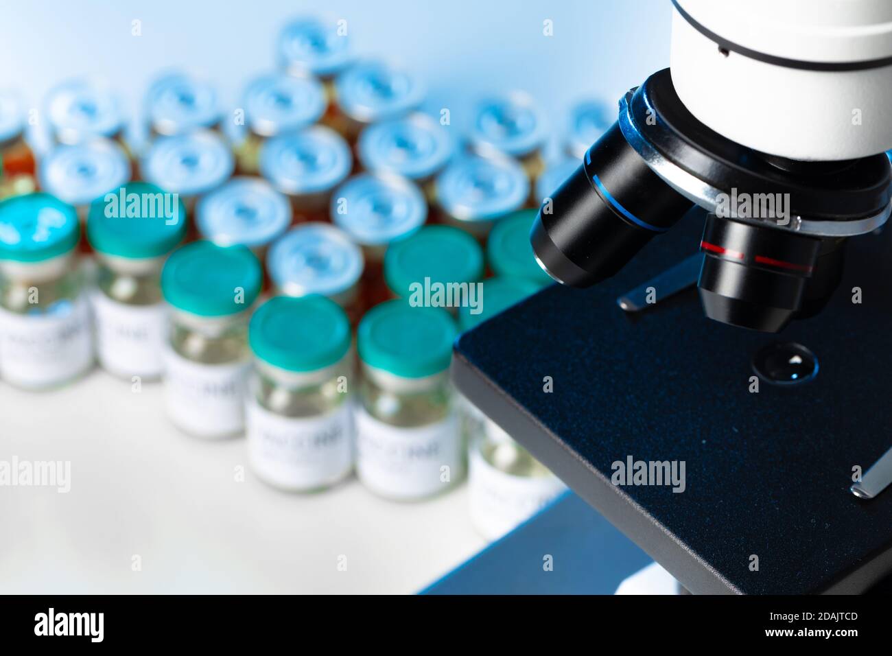 Medical vial with medication near microscope close up Stock Photo - Alamy