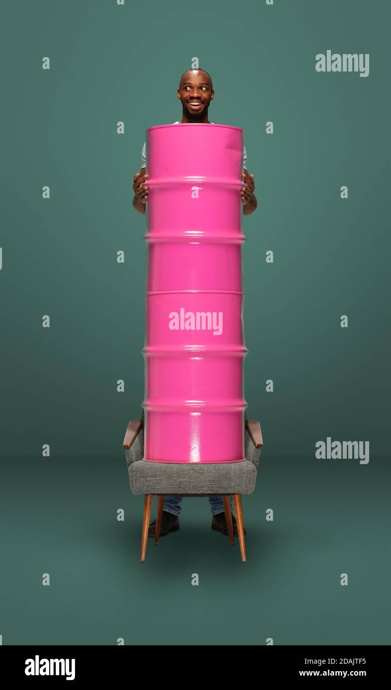 Tall high man and long barrel isolated on green studio background ...