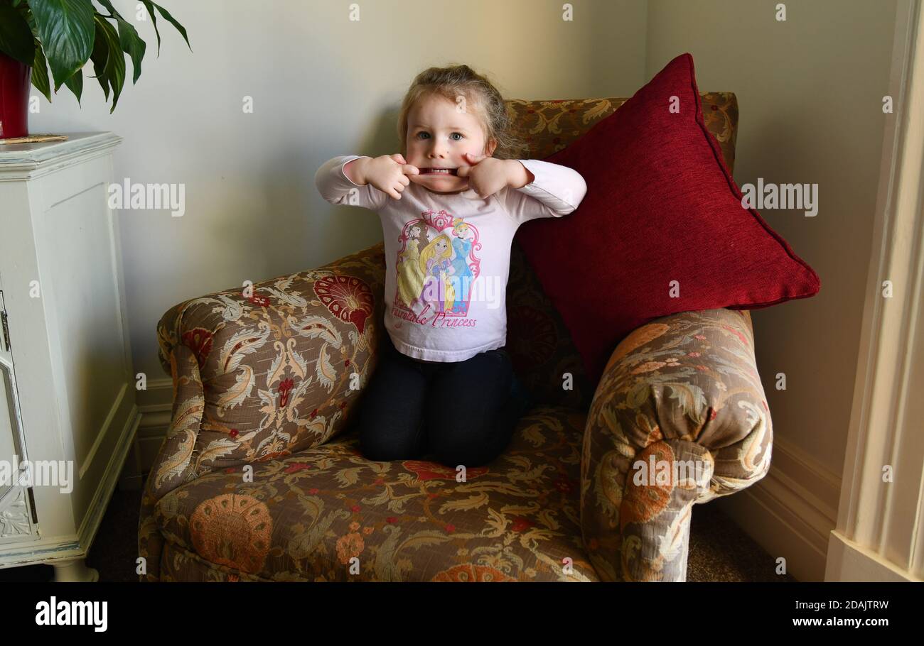 Cute child toddler girl pulling a funny face Stock Photo - Alamy
