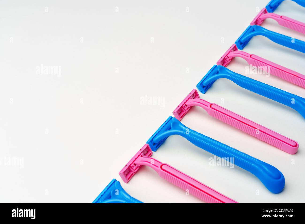 Pink and blue razors on white background Stock Photo - Alamy