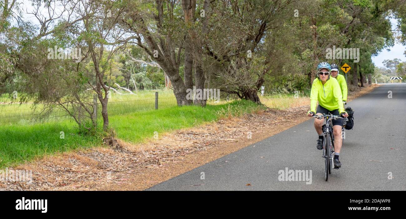 Touring cyclists travelling on vacation riding bicycles on a country ...