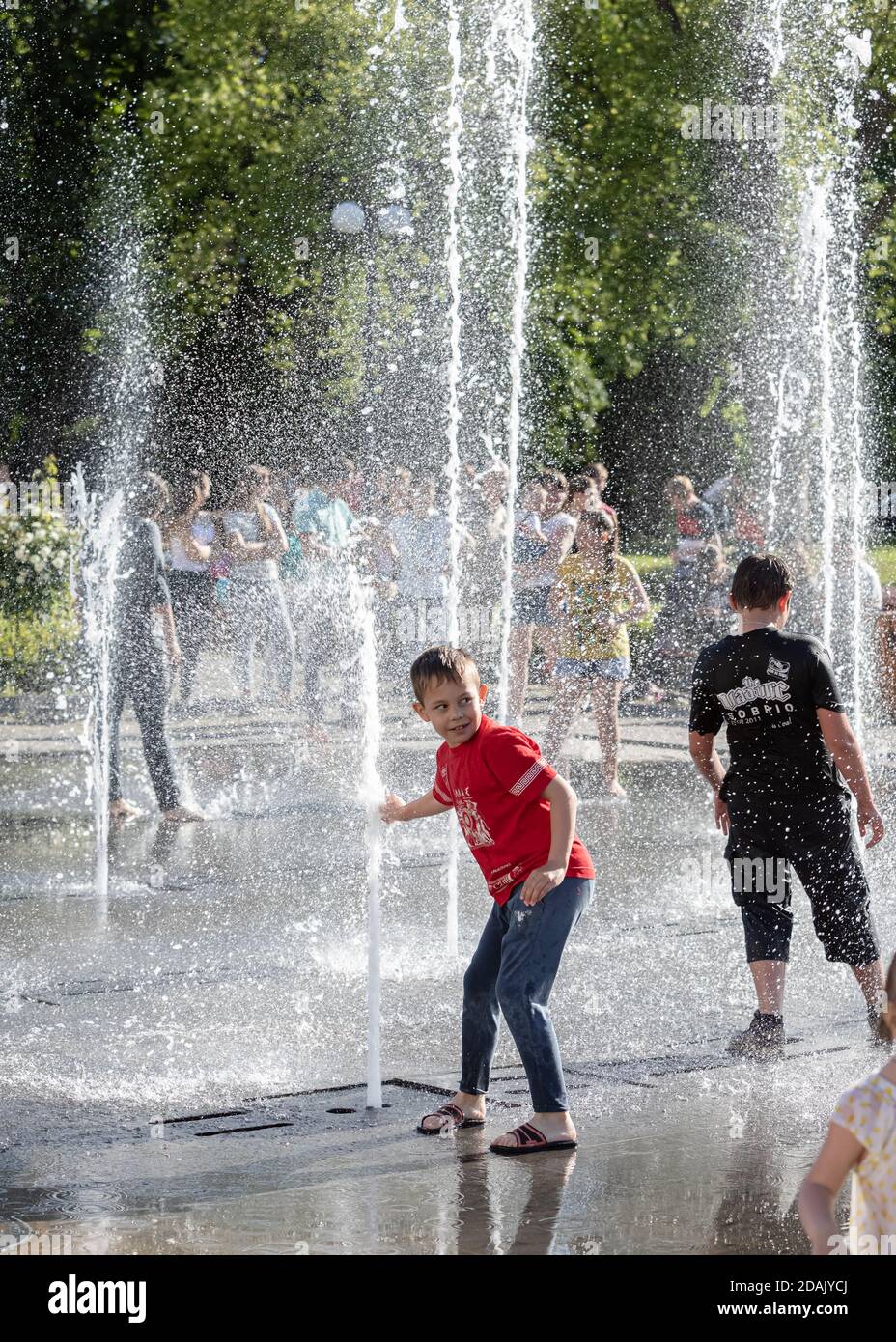 UZHGOROD, UKRAINE - May 28, 2017: Happy children playing in a water ...