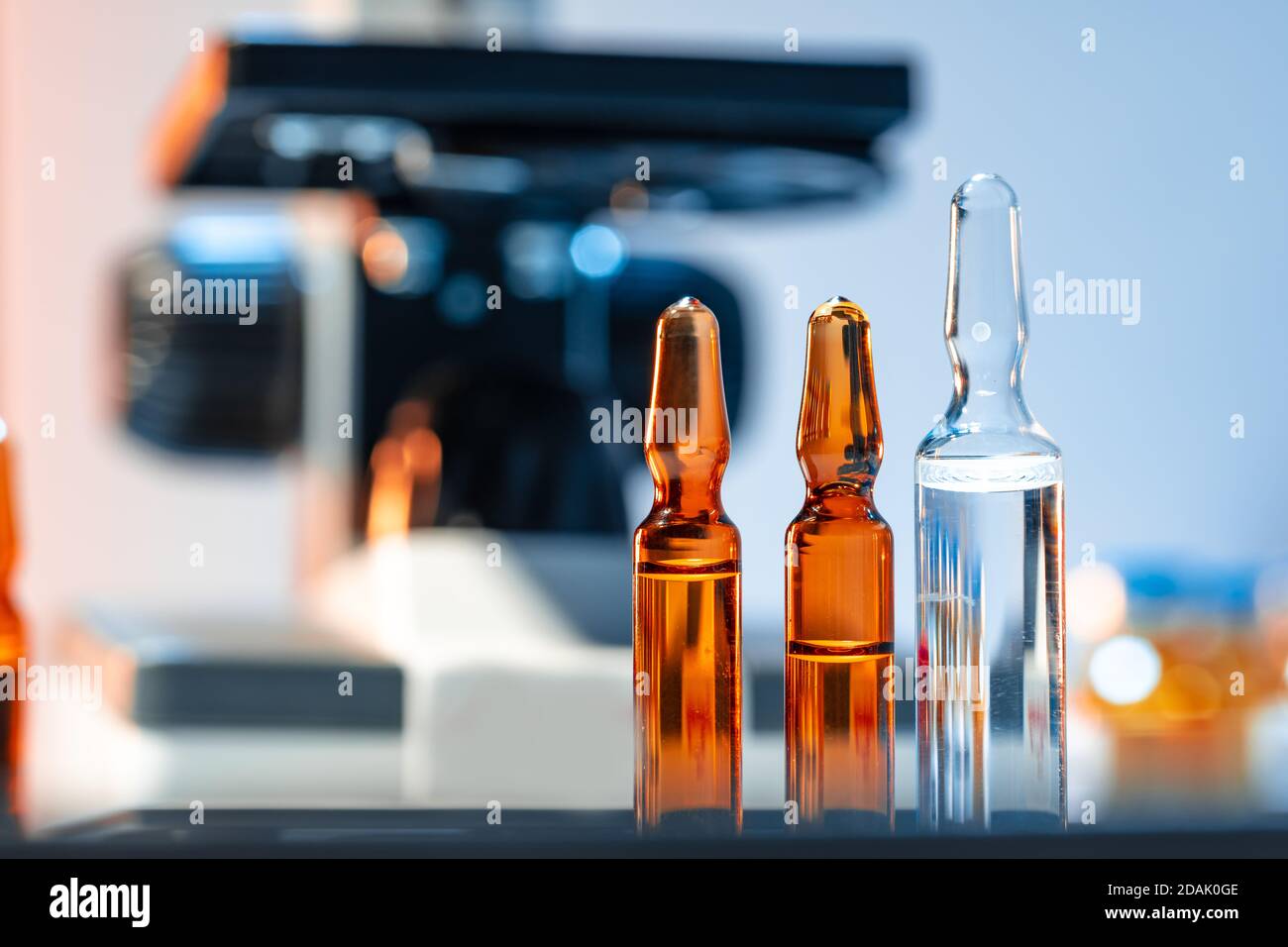 Medical vial with medication near microscope photo Stock Photo - Alamy