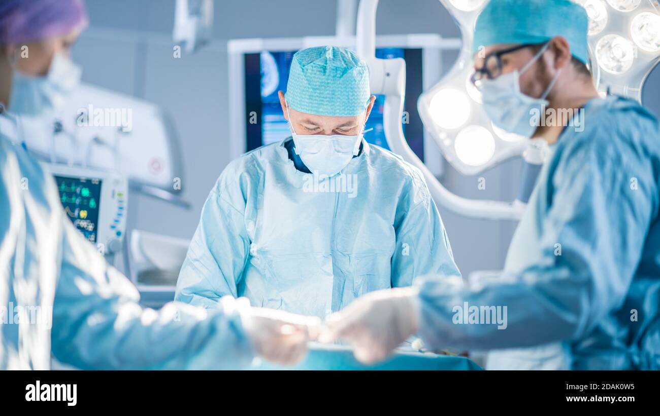 Shot in the Operating Room, Assistant Hands out Instruments to Surgeons ...