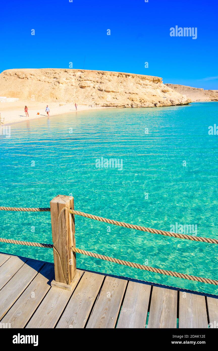 Wooden Pier at Orange Bay Beach with crystal clear azure water and ...