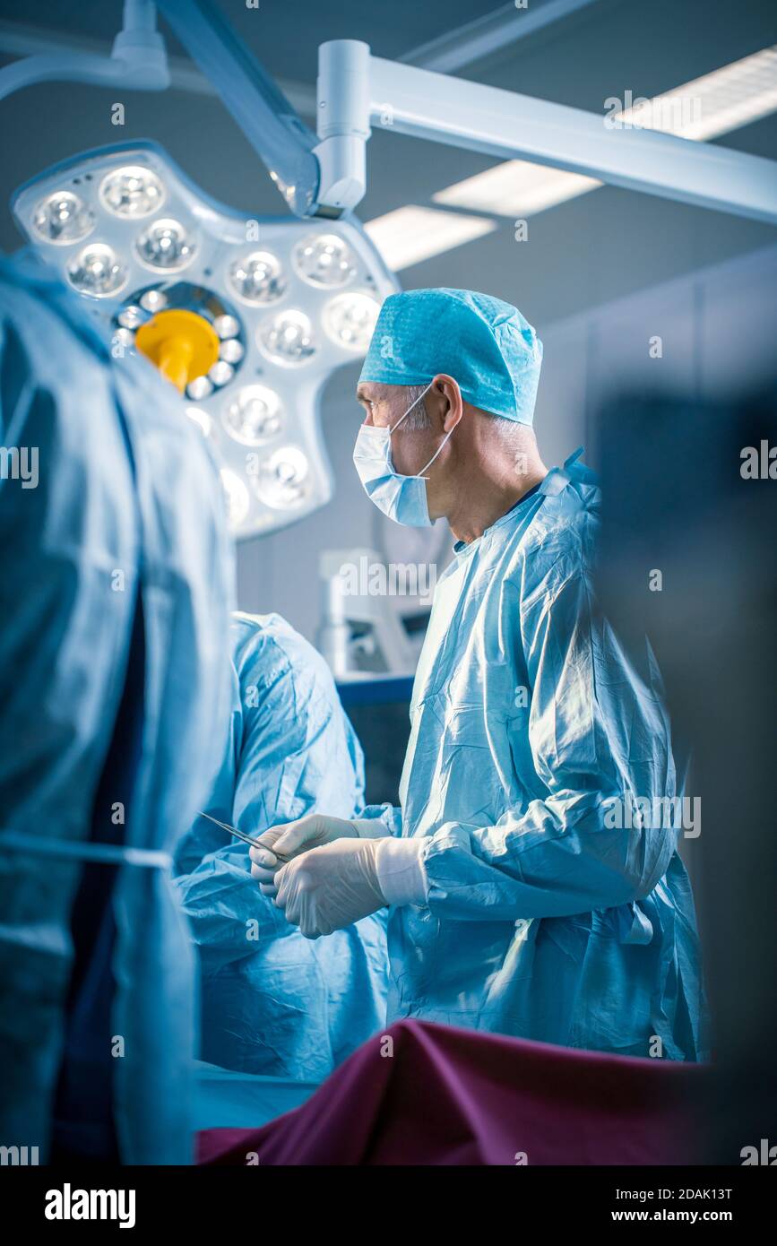 Portrait of the Professional Surgeon Performing Invasive Surgery on a ...