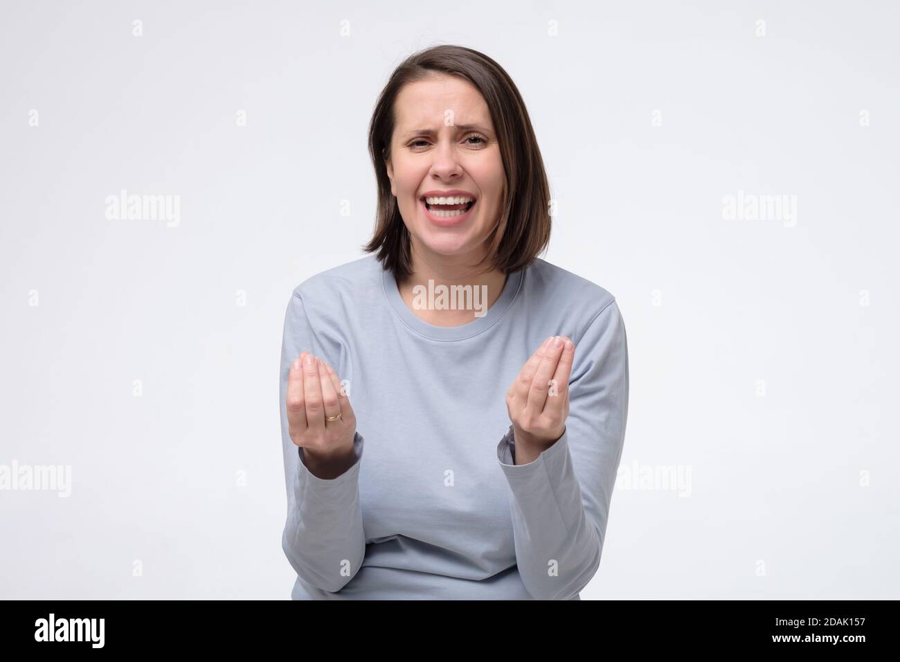Mature woman doing Italian gesture with hand and fingers trying to ...