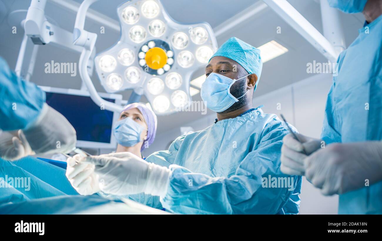 Diverse Team of Professional surgeon, Assistants and Nurses Performing ...
