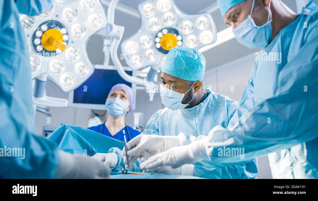 Diverse Team of Professional surgeon, Assistants and Nurses Performing ...