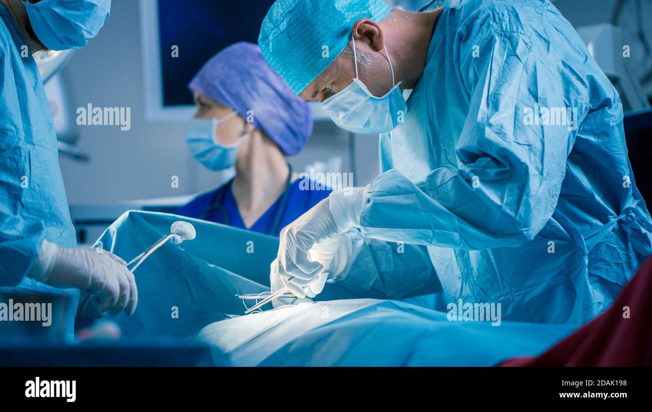 In the Hospital Operating Room Diverse Team of Professional Surgeons ...