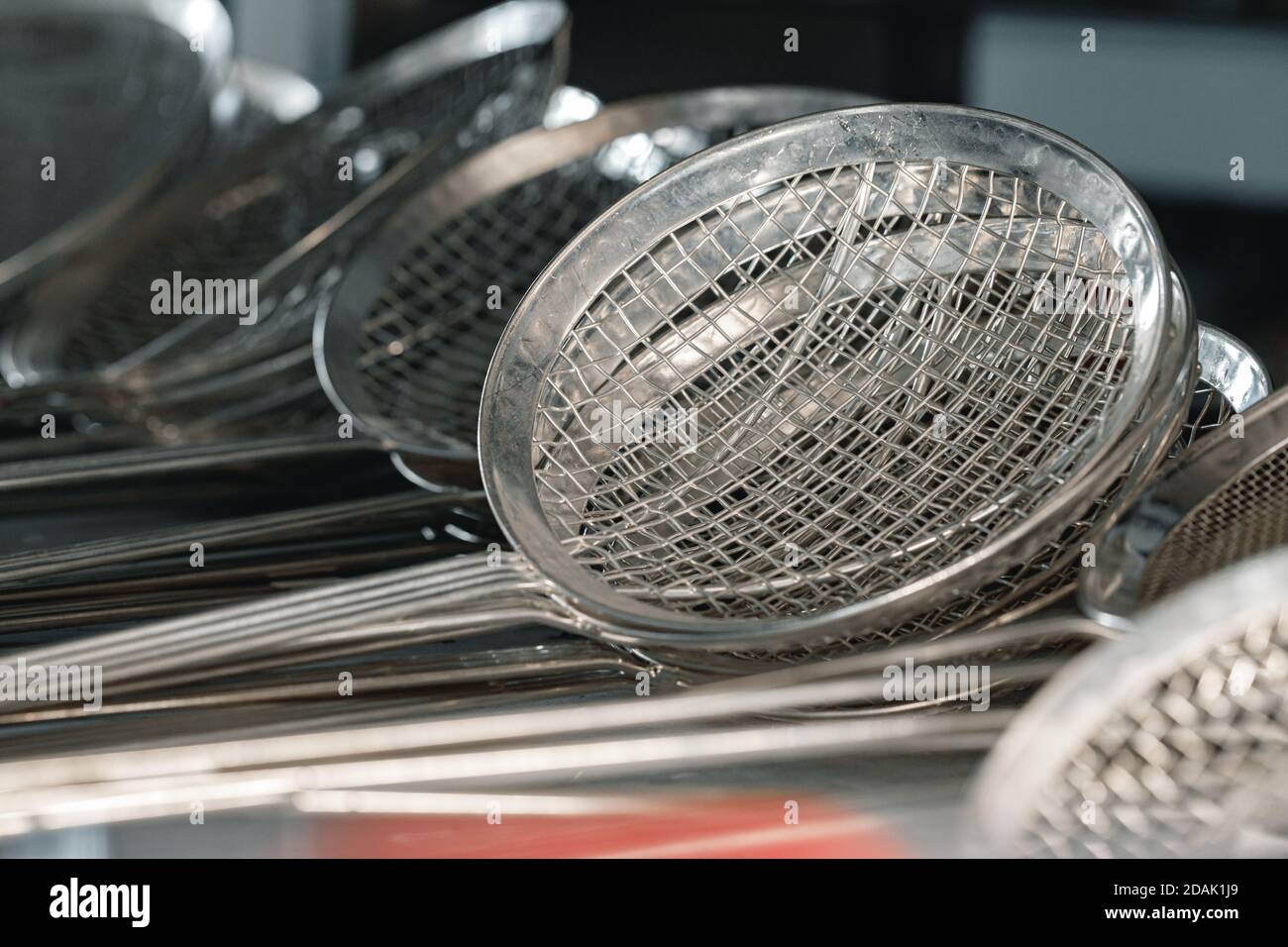 New metal kitchenware in a row close up Stock Photo - Alamy