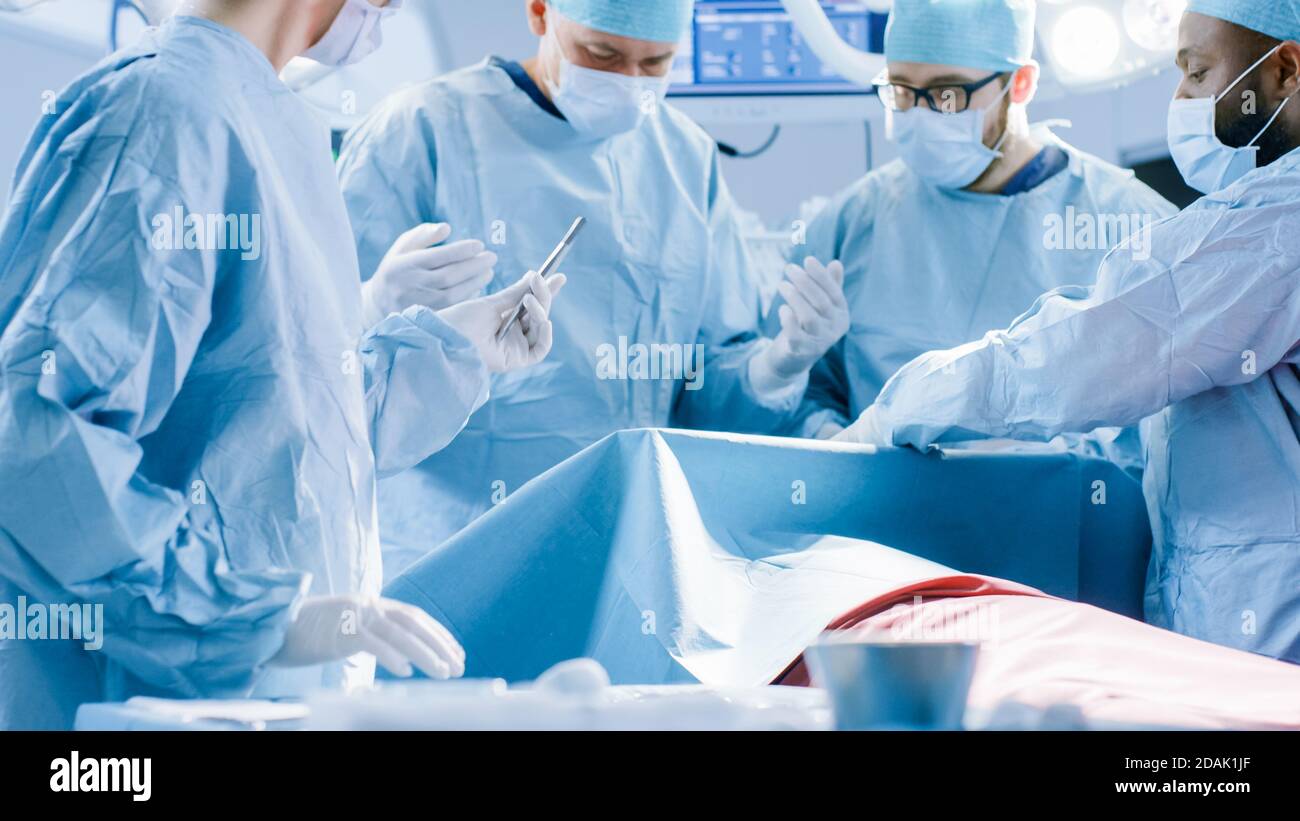 Diverse Team of Professional surgeon, Assistants and Nurses Performing ...