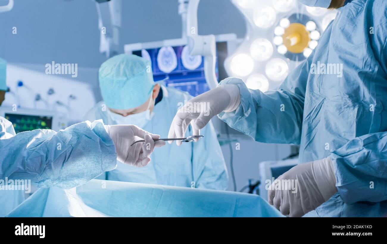 Close-up Shot in the Operating Room, Assistant Hands out Instruments to ...
