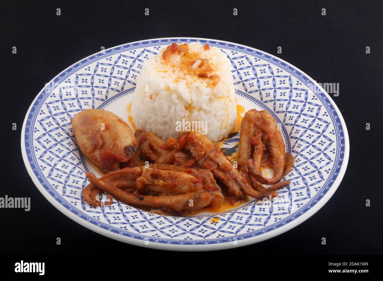 octopus cooked with onions and white rice side Stock Photo - Alamy