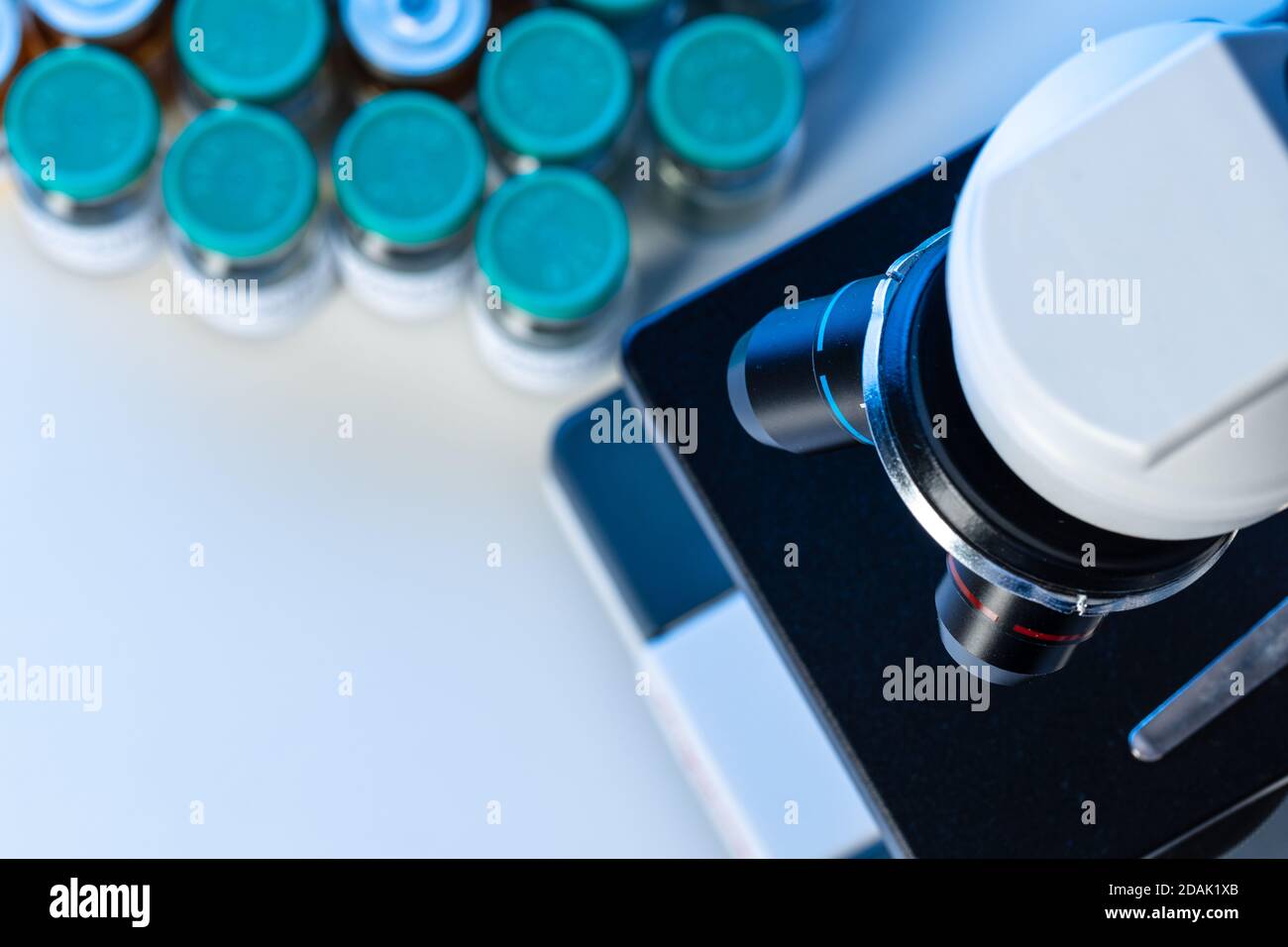 Medical vial with medication near microscope photo Stock Photo - Alamy
