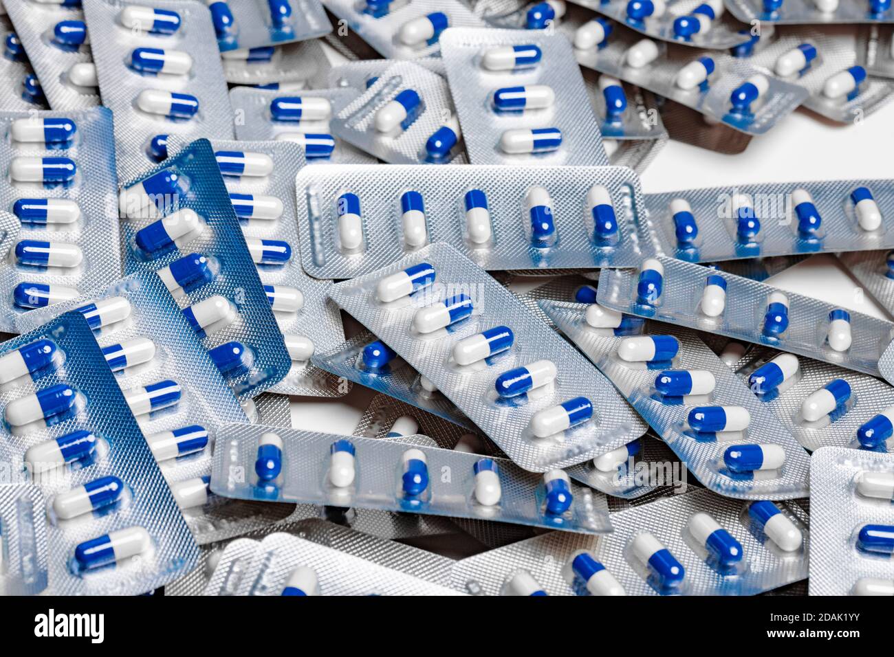 Blue and white capsule pills in blister packs Stock Photo - Alamy