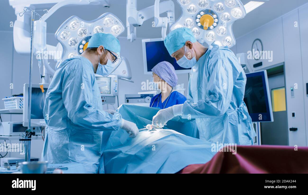 In the Hospital Operating Room Diverse Team of Professional Surgeons ...