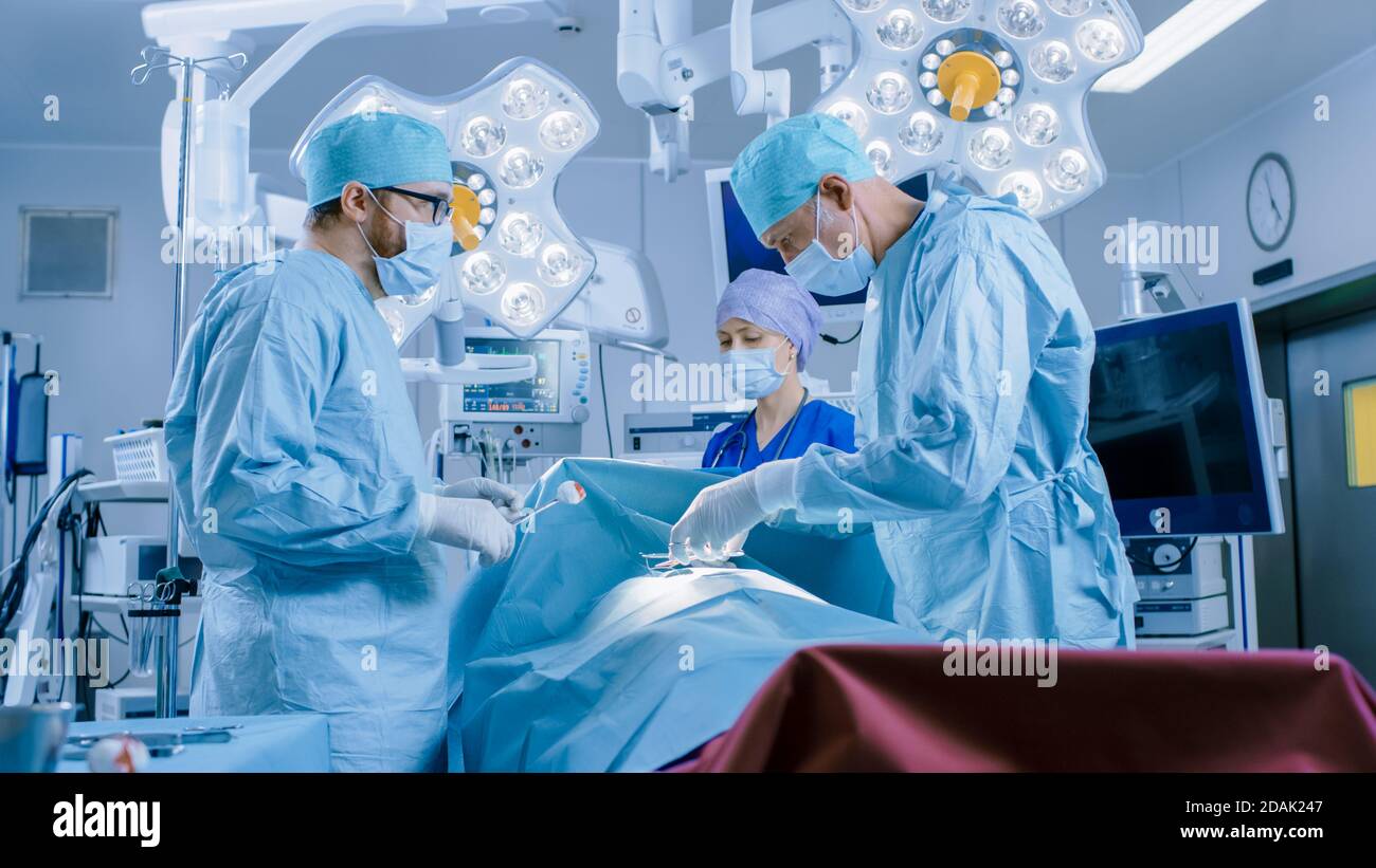 In the Hospital Operating Room Diverse Team of Professional Surgeons ...