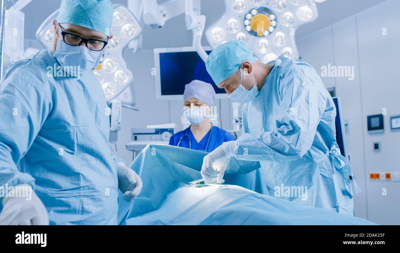 In the Hospital Operating Room Diverse Team of Professional Surgeons ...