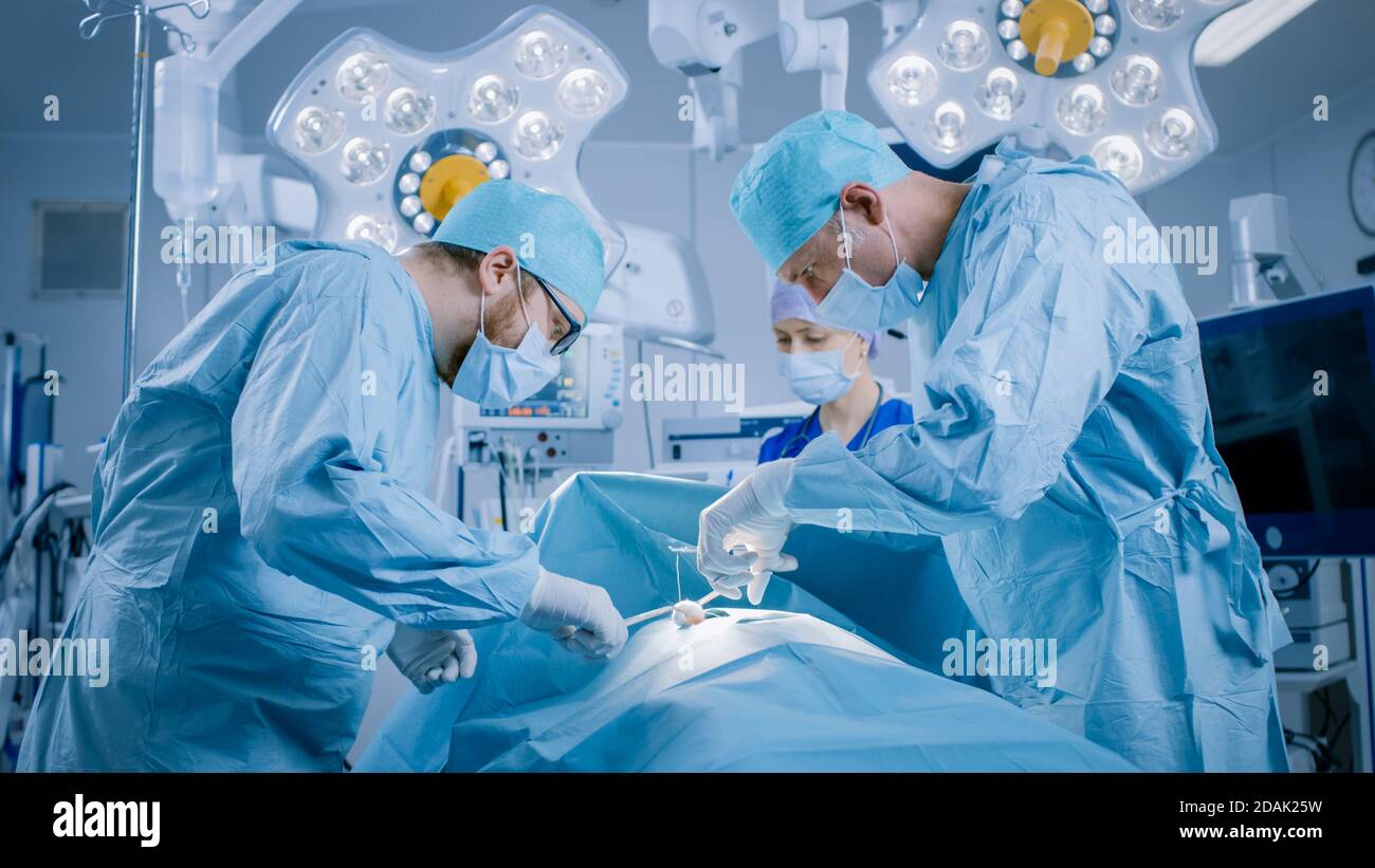 In the Hospital Operating Room Diverse Team of Professional Surgeons ...