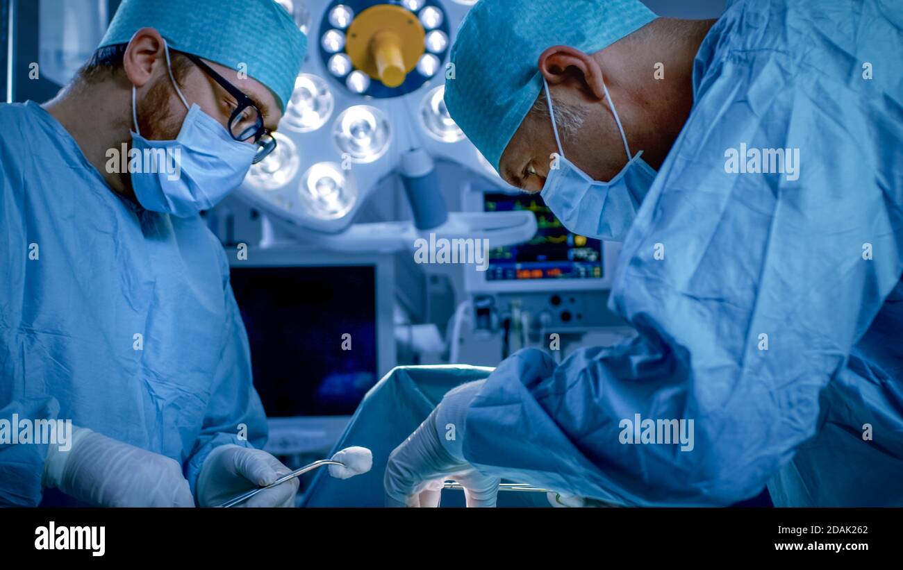 In the Hospital Operating Room Diverse Team of Professional Surgeons ...