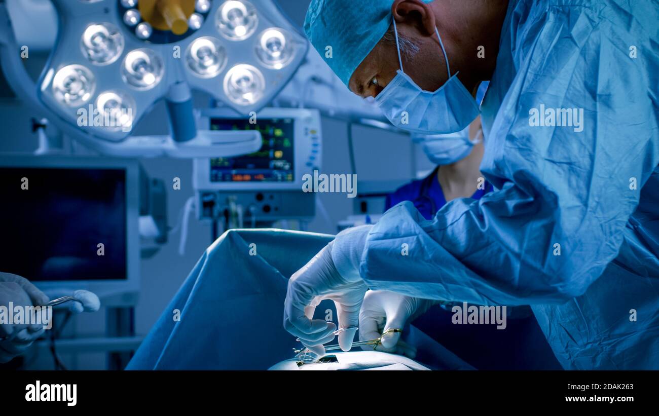 In the Hospital Operating Room Diverse Team of Professional Surgeons ...
