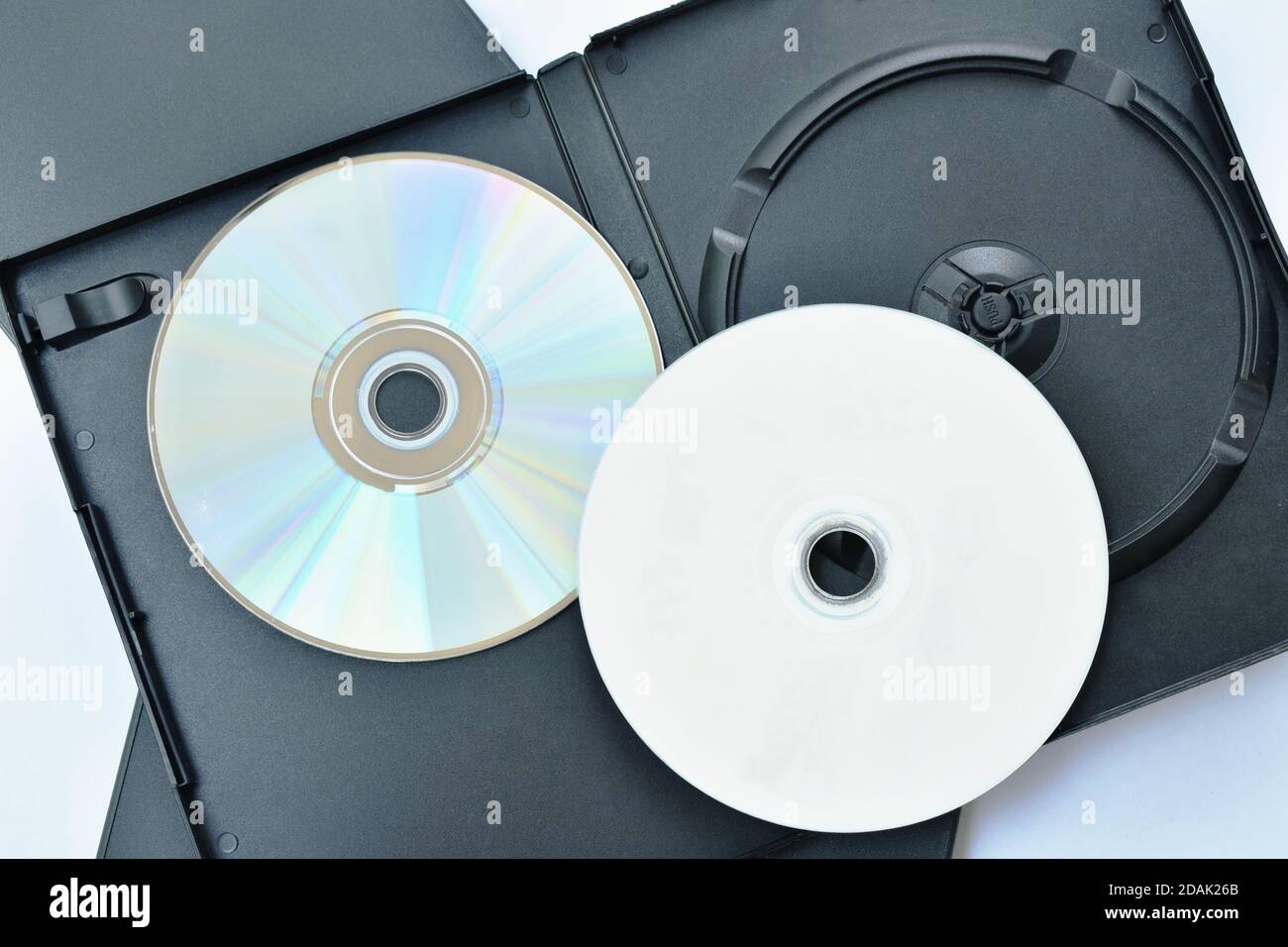 digital versatile disc or DVD with black plastic box packaging on white ...