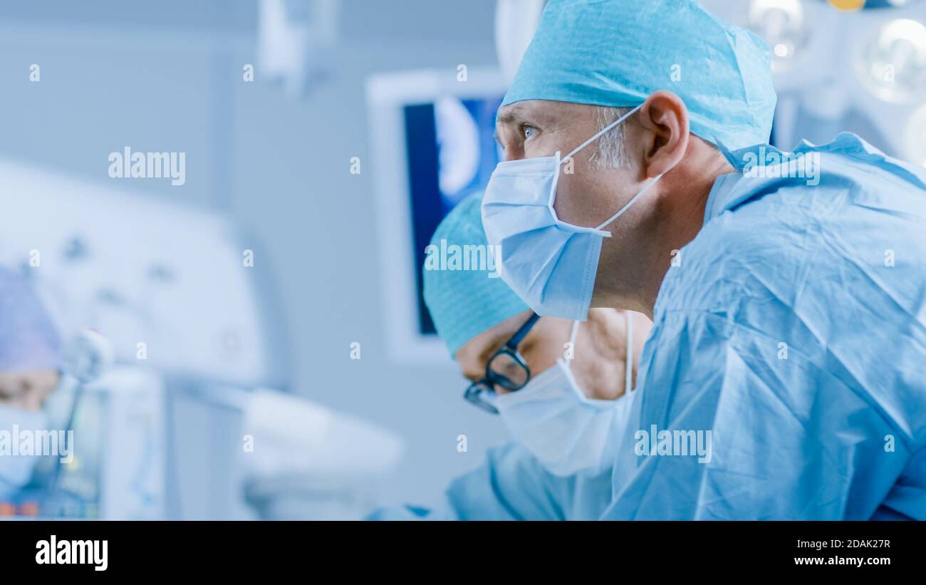 Diverse Team of Professional Surgeons Performing Invasive Surgery on a ...
