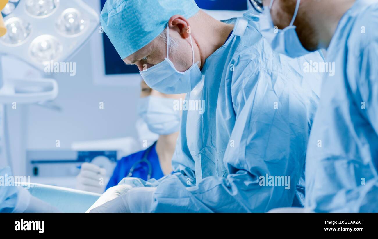 In the Hospital Operating Room Diverse Team of Professional Surgeons ...