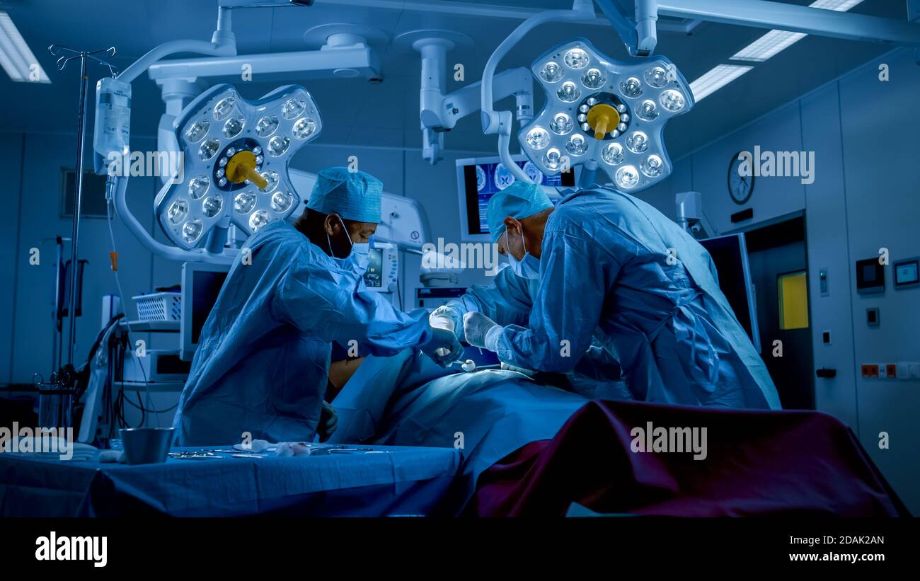 Diverse Team of Professional Surgeons Performing Invasive Surgery on a ...