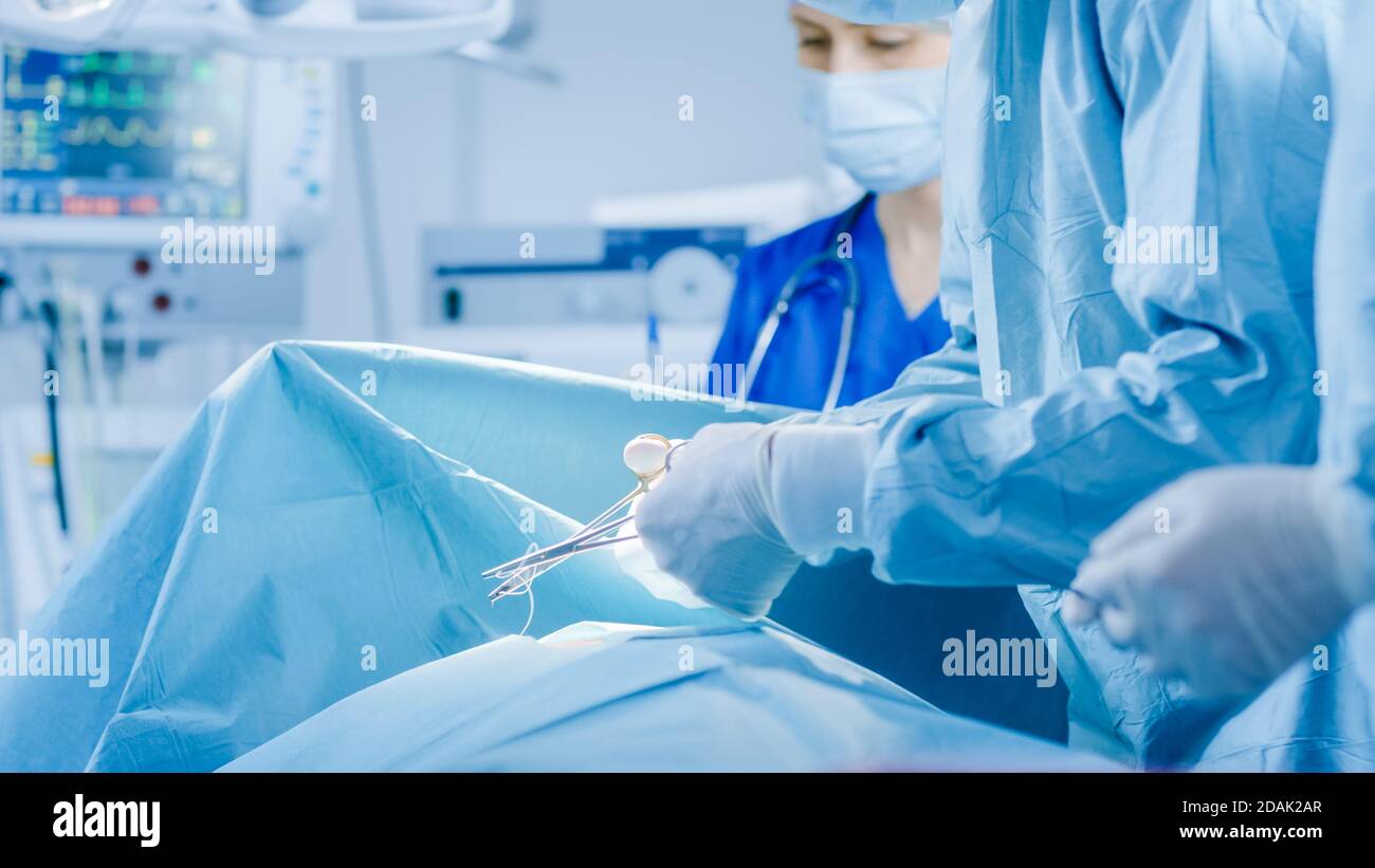 In the Hospital Operating Room Diverse Team of Professional Surgeons ...