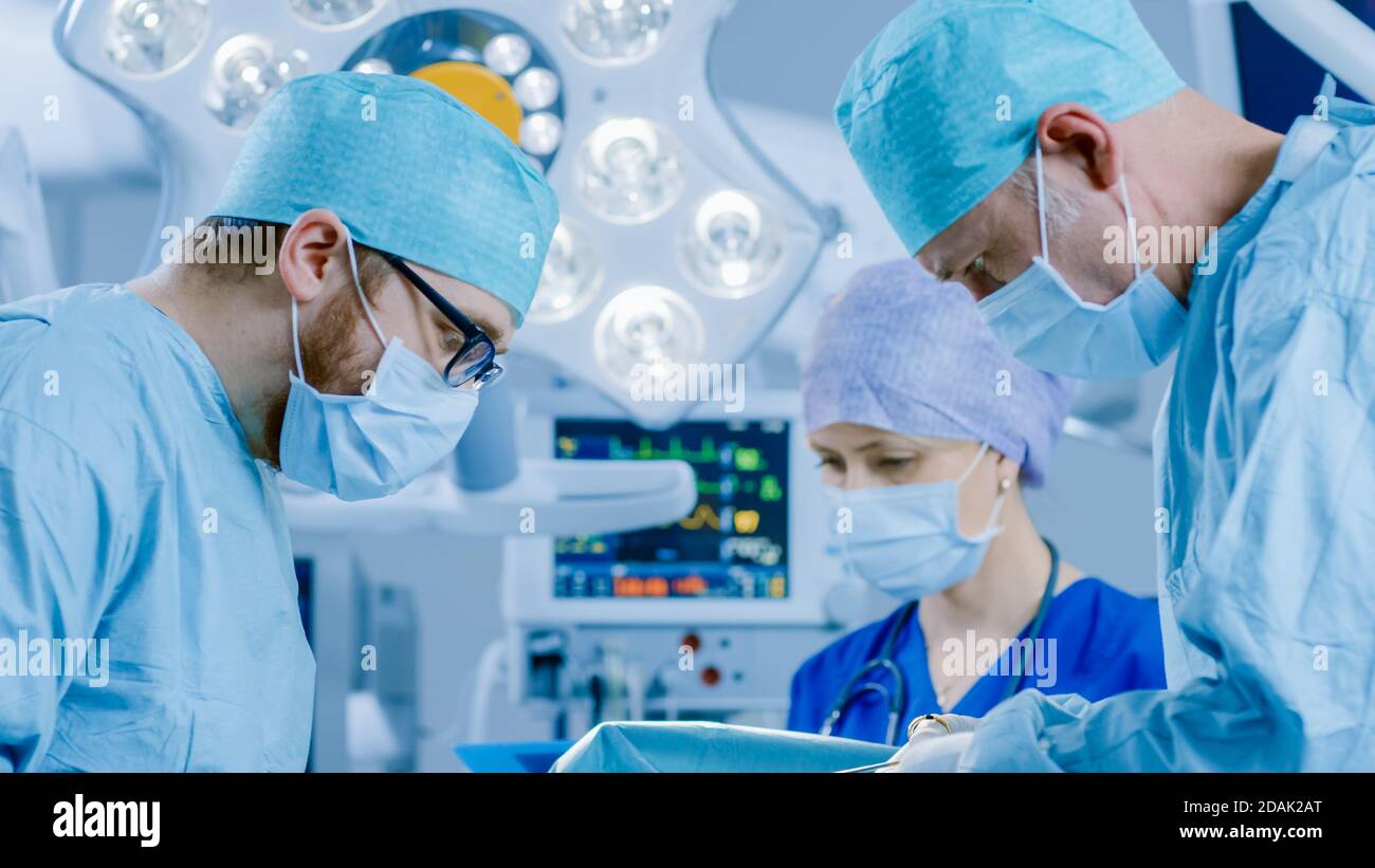 In the Hospital Operating Room Diverse Team of Professional Surgeons ...