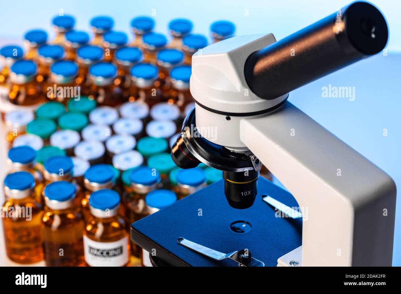 Medical vial with medication near microscope photo Stock Photo - Alamy