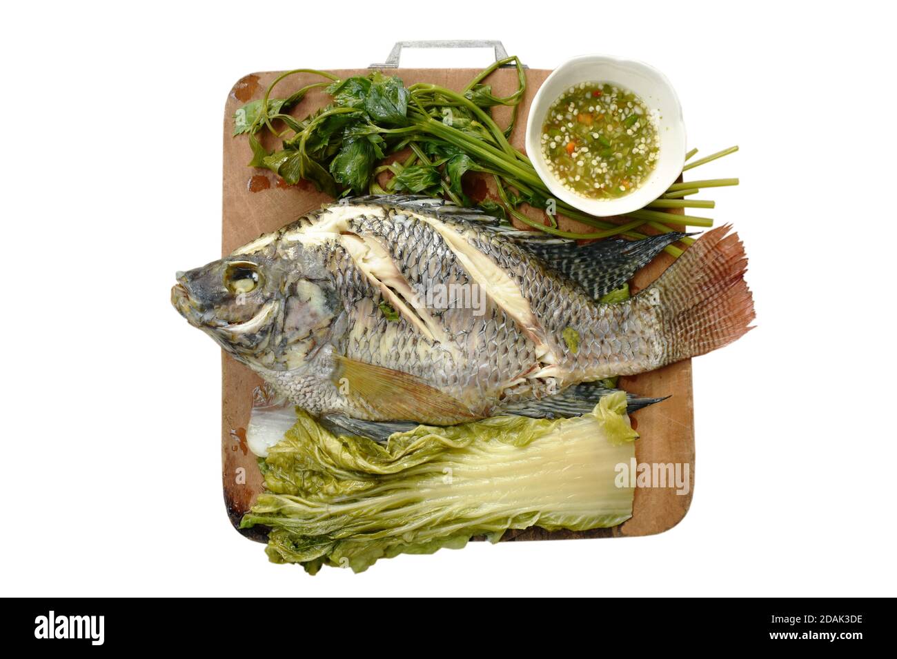 steamed mango fish with vegetable dipping spicy sauce on wooden chop ...