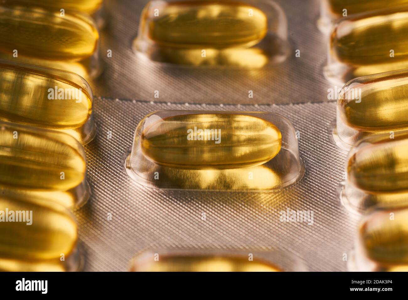 Metal blister with yellow medicinal capsules close-up Stock Photo - Alamy
