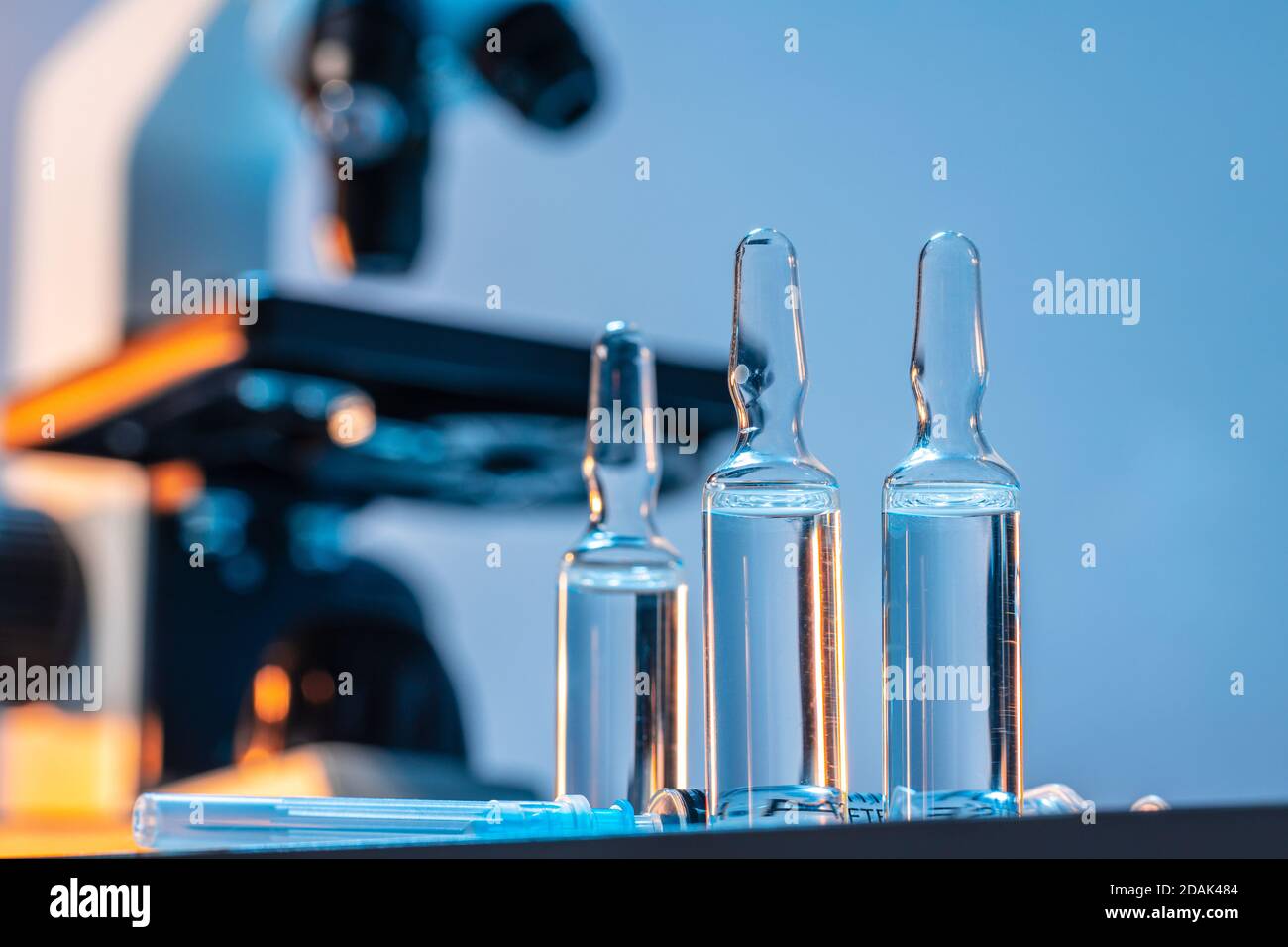 Medical vial with medication near microscope photo Stock Photo - Alamy