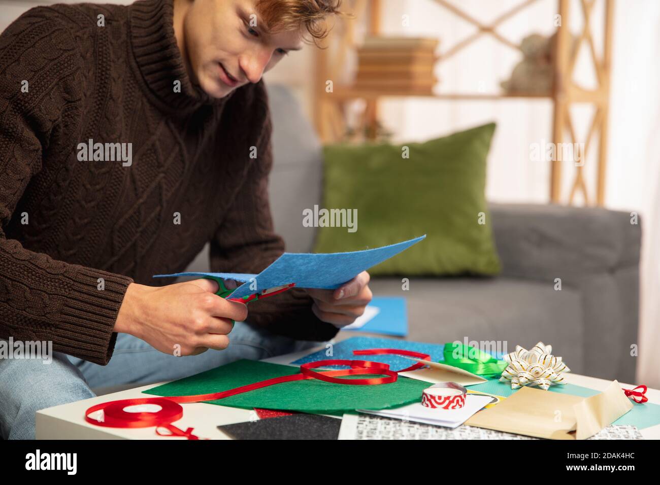 Young man making greeting card for New Year and Christmas 2021 for ...