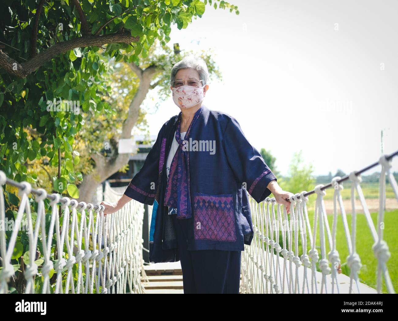 asian elderly woman elder wearing facial mask resting relaxing outdoors ...