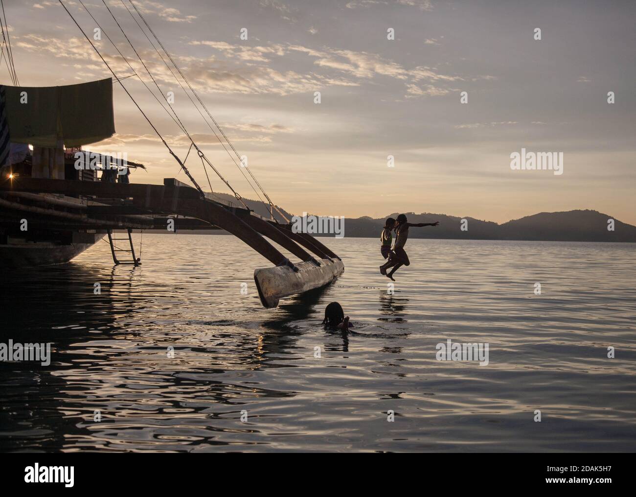 Children jumping off from the traditional Paraw at remote island of ...