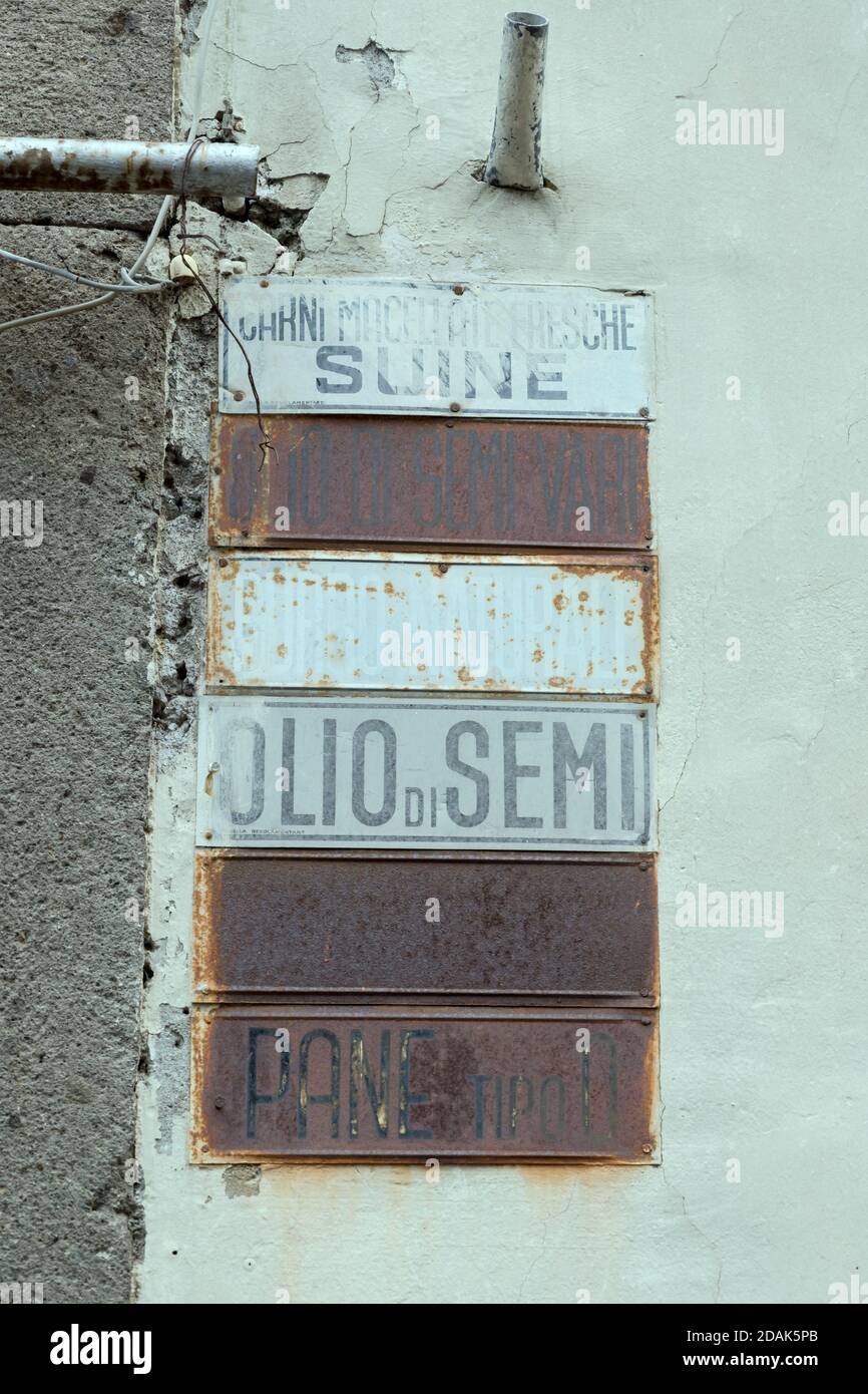 detail of rusty food-stuff signs on wall of old grocery store at ...