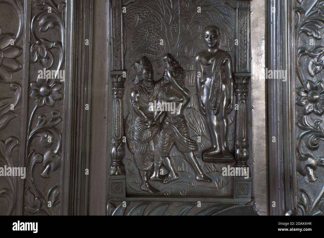 Religious gods or deities embossed on the metal doors of a temple in ...