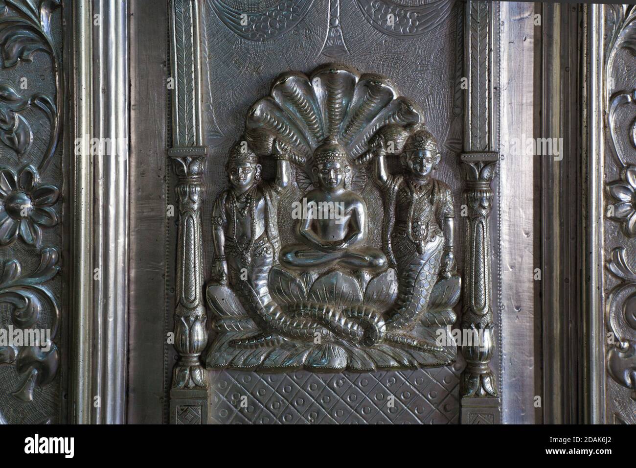 Religious gods or deities embossed on the metal doors of a temple in ...